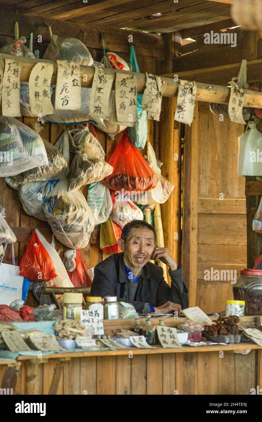 An older Chinese man selling traditional herbal medicines by a trail in ...