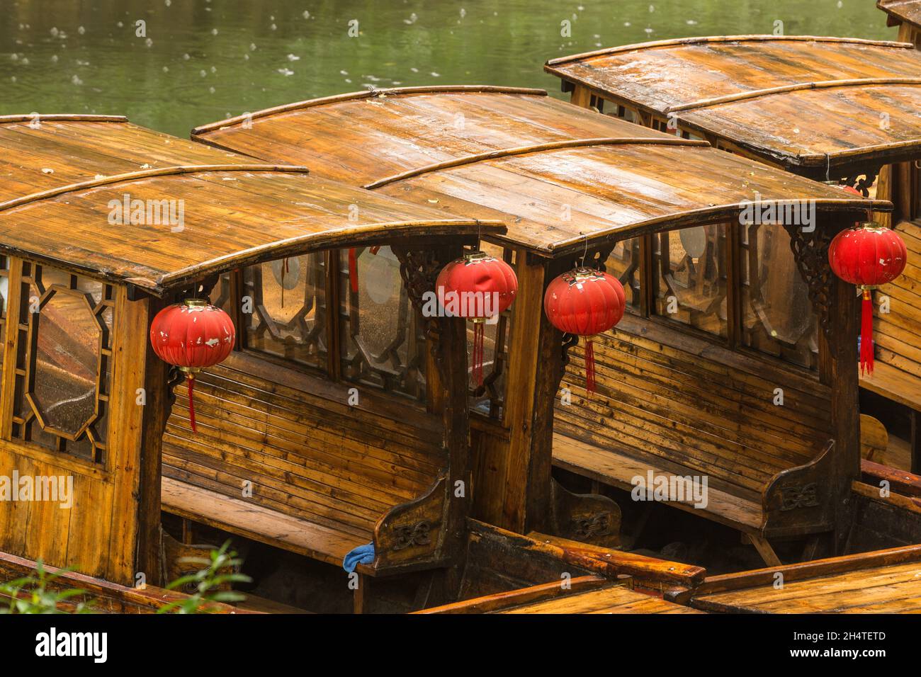 Covered wooden tour boats moored on the moat around the Tiger Hill in ...