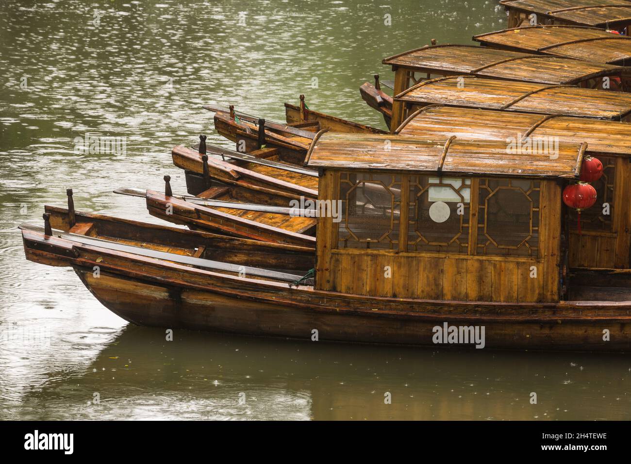 Covered wooden tour boats moored on the moat around the Tiger Hill in ...