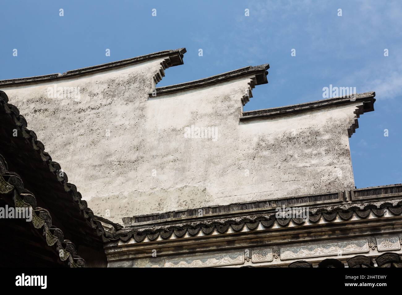 A traditional gable and decorative clay roof tiles on an old building ...