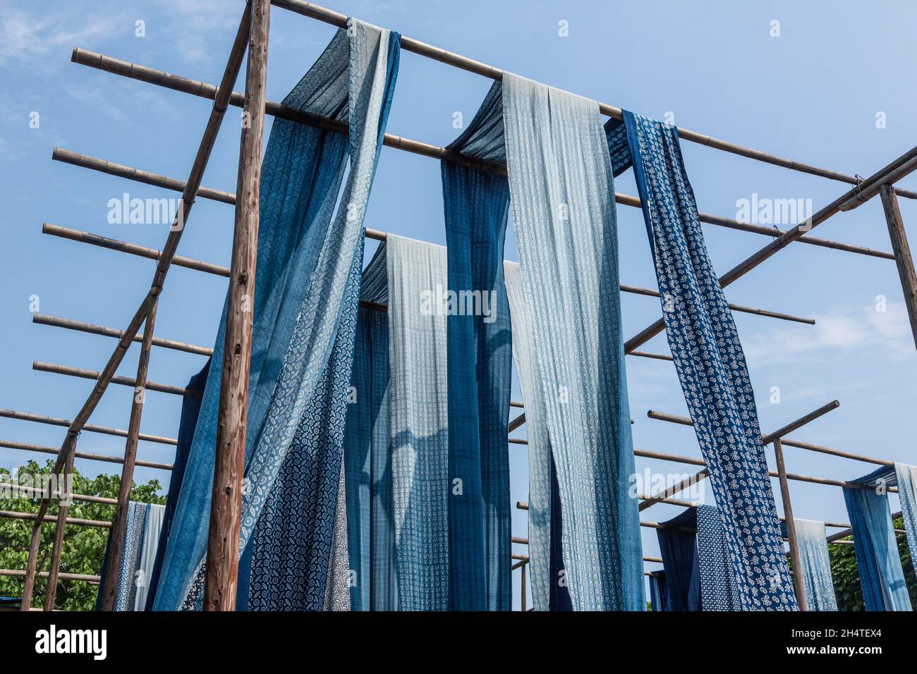 Traditionally dyed blue indigo cloth drying on racks in the town of ...