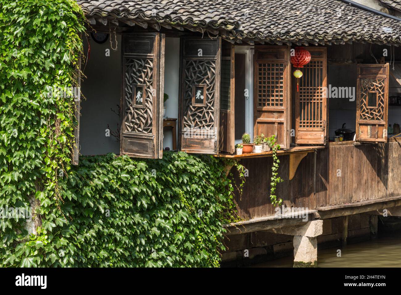Wooden lattice windows on traditional dwellings along the canal in the ...
