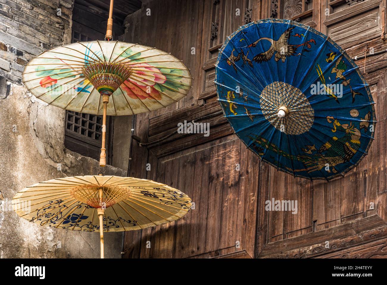 Colorful hand-painted parasols on display on a shop in the town of ...