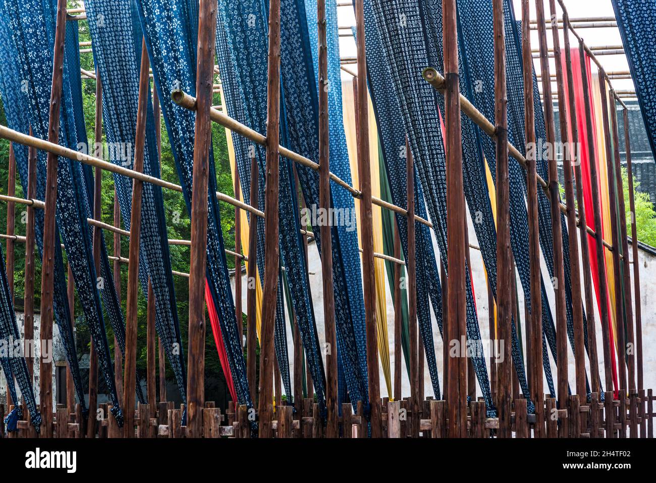 Traditionally dyed blue indigo cloth drying on racks in the town of ...