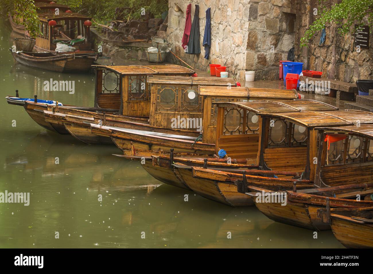 Covered wooden tour boats moored on the moat around the Tiger Hill in ...