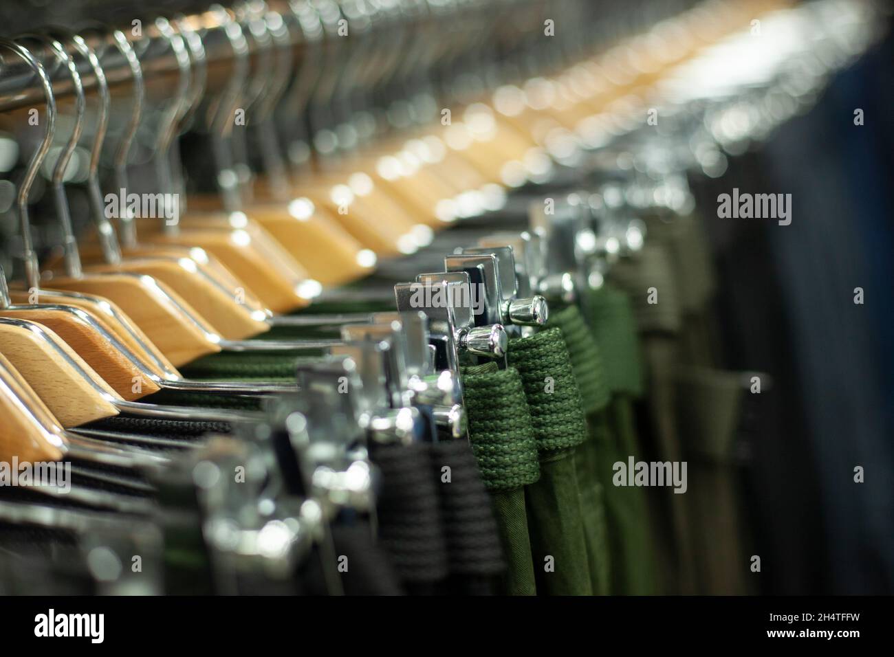 Pants in the store on hangers. Details of the clothing store. Placement ...