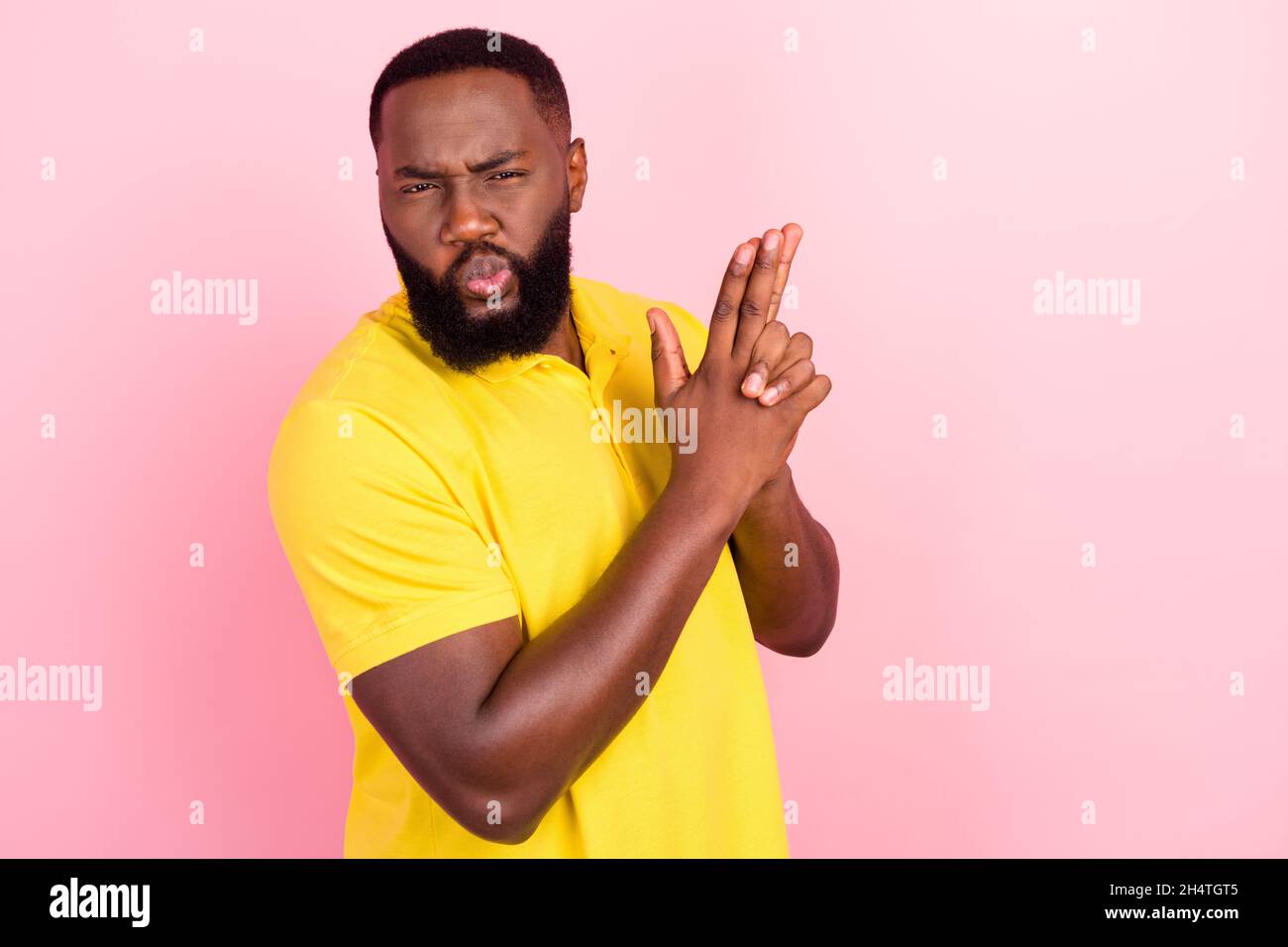 Portrait of attractive funky cool guy showing gun symbol isolated over ...