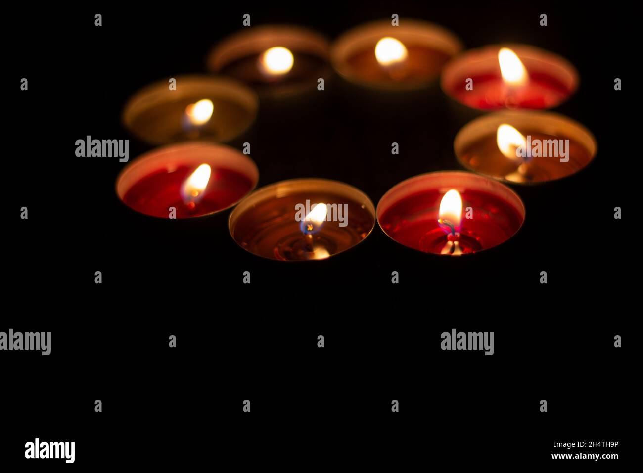 Candles are collected in a circle. A circle of wax candles. Liquid wax ...
