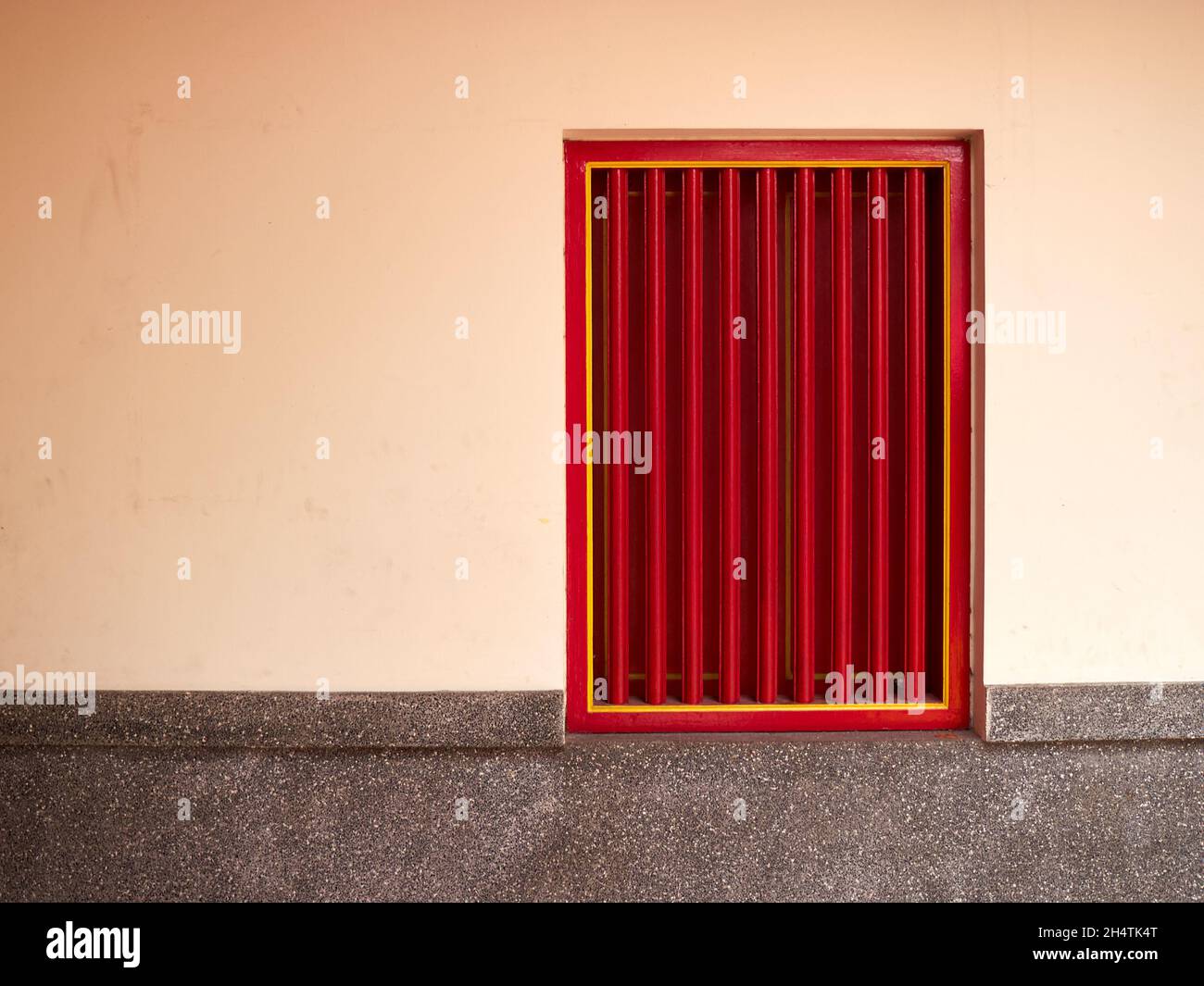 Beige wall with a window with red frames Stock Photo - Alamy