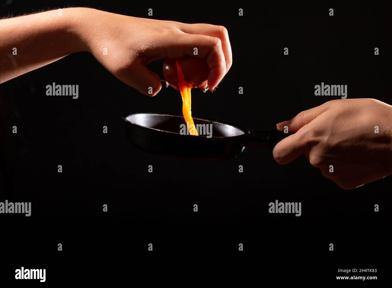 Hand dropping egg hi-res stock photography and images - Alamy