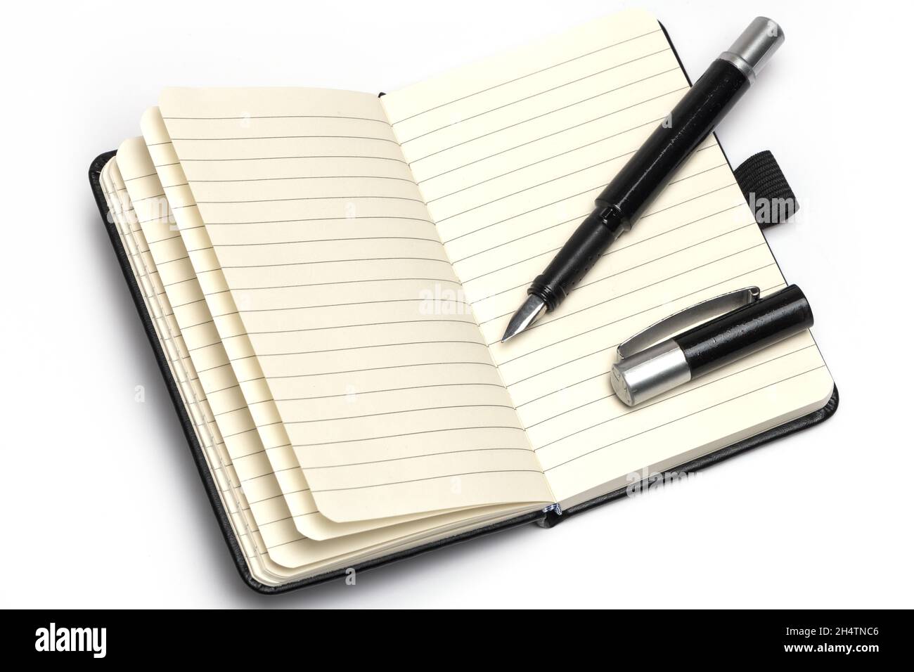 Close up of opened vintage leather notebook with fountain pen isolated ...