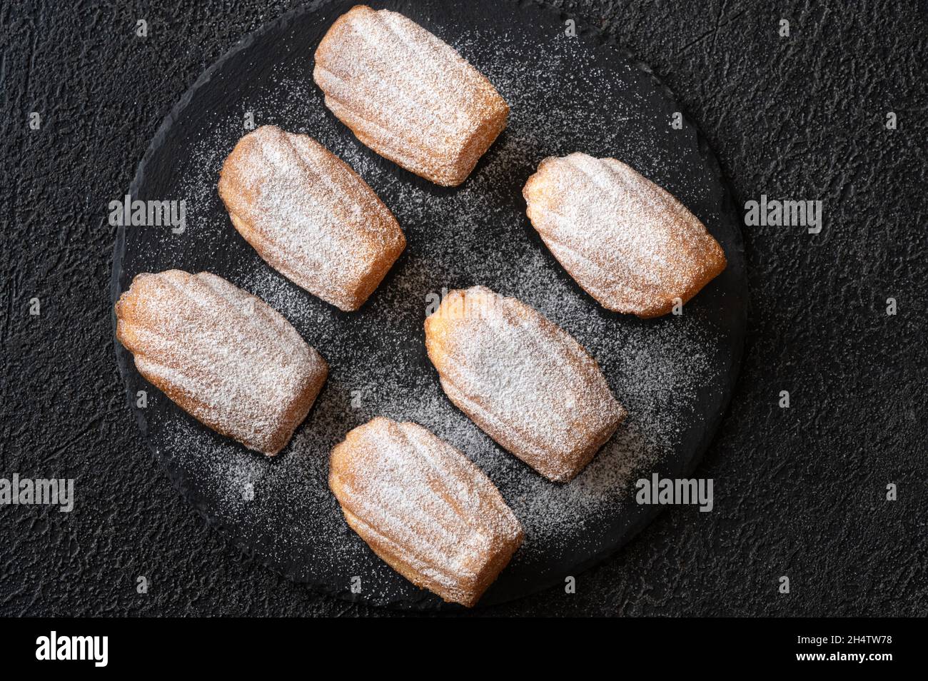 Madeleines - French small sponge cakes on the stone board Stock Photo ...