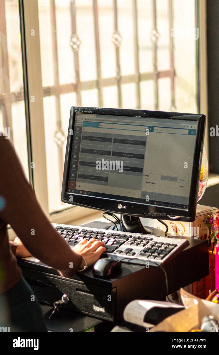 Employee working in a local store Stock Photo - Alamy