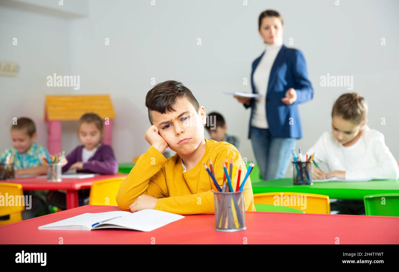 Upset boy in schoolroom Stock Photo - Alamy