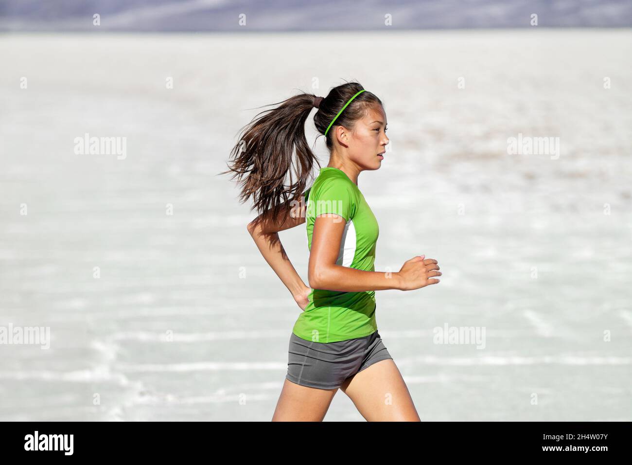 Runner athlete woman running trail run race in desert background. Long ...