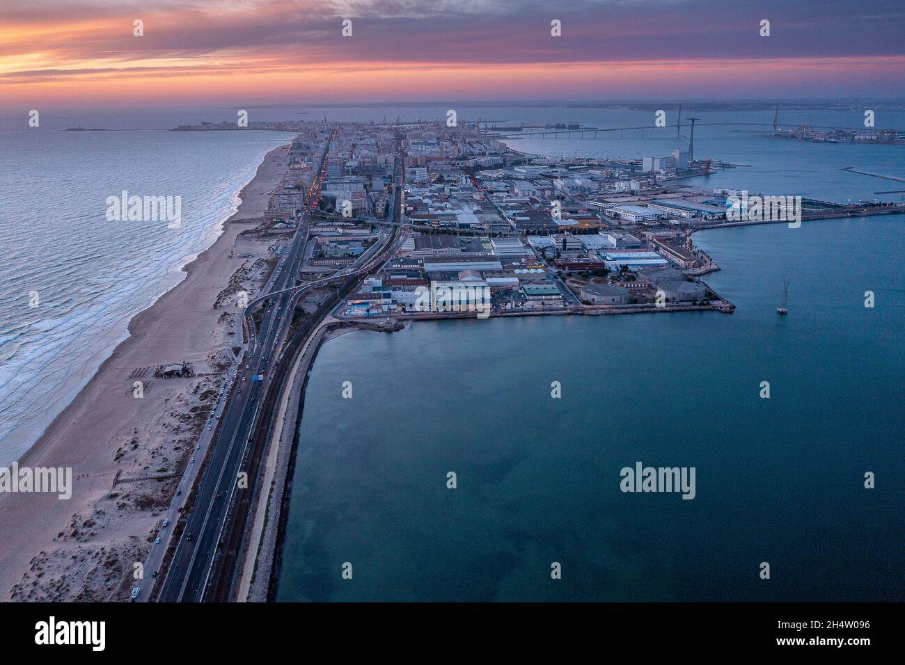Cadiz in Background. Aerial view of the beach and road CA-33 also ...