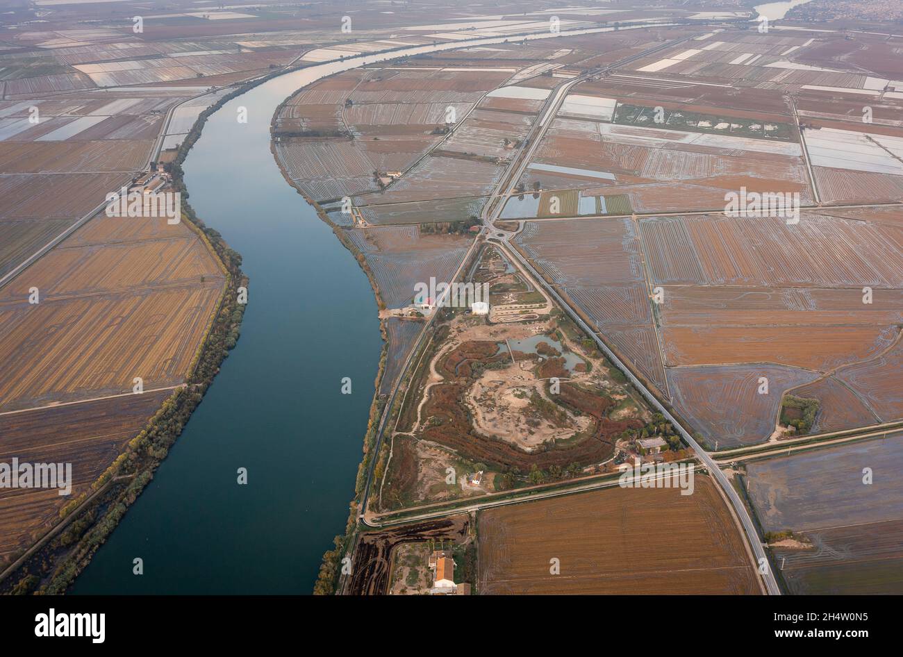 Aerial view of Ebro river and rice fields, in Ebro Delta, Natural Park ...