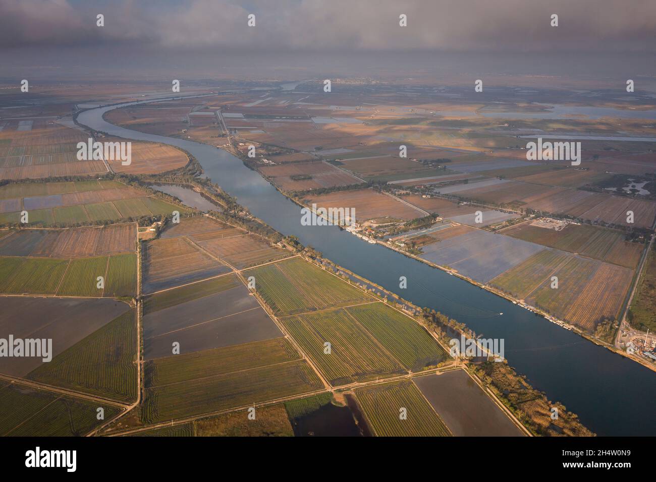 Aerial view of Ebro river and rice fields, in Ebro Delta, Natural Park ...