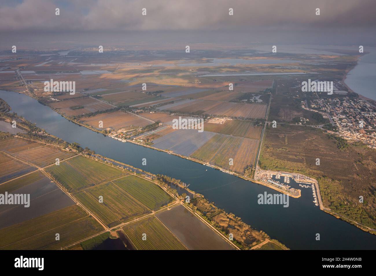 Aerial view of Ebro river and rice fields, in Ebro Delta, Natural Park ...