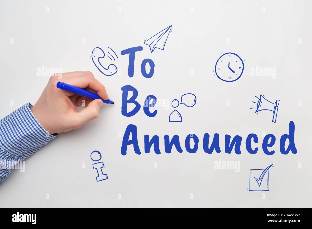 Business acronym TBA or To Be Announced. Person writes with a marker on ...