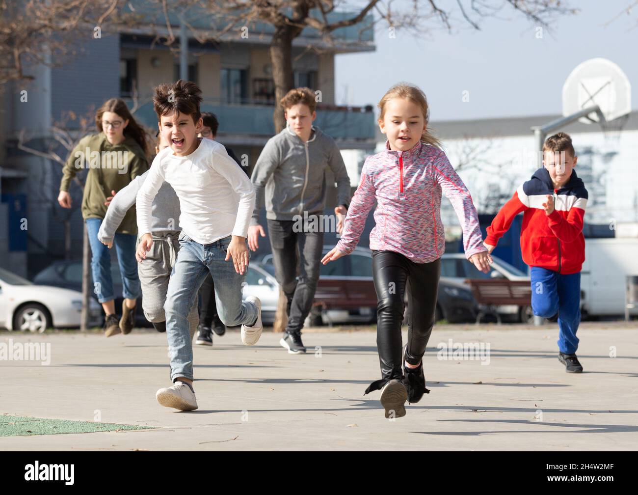 Happy children running on city street Stock Photo - Alamy