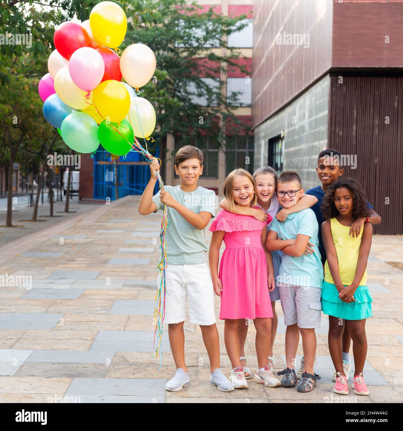 Children with balloons standing outdoors Stock Photo - Alamy