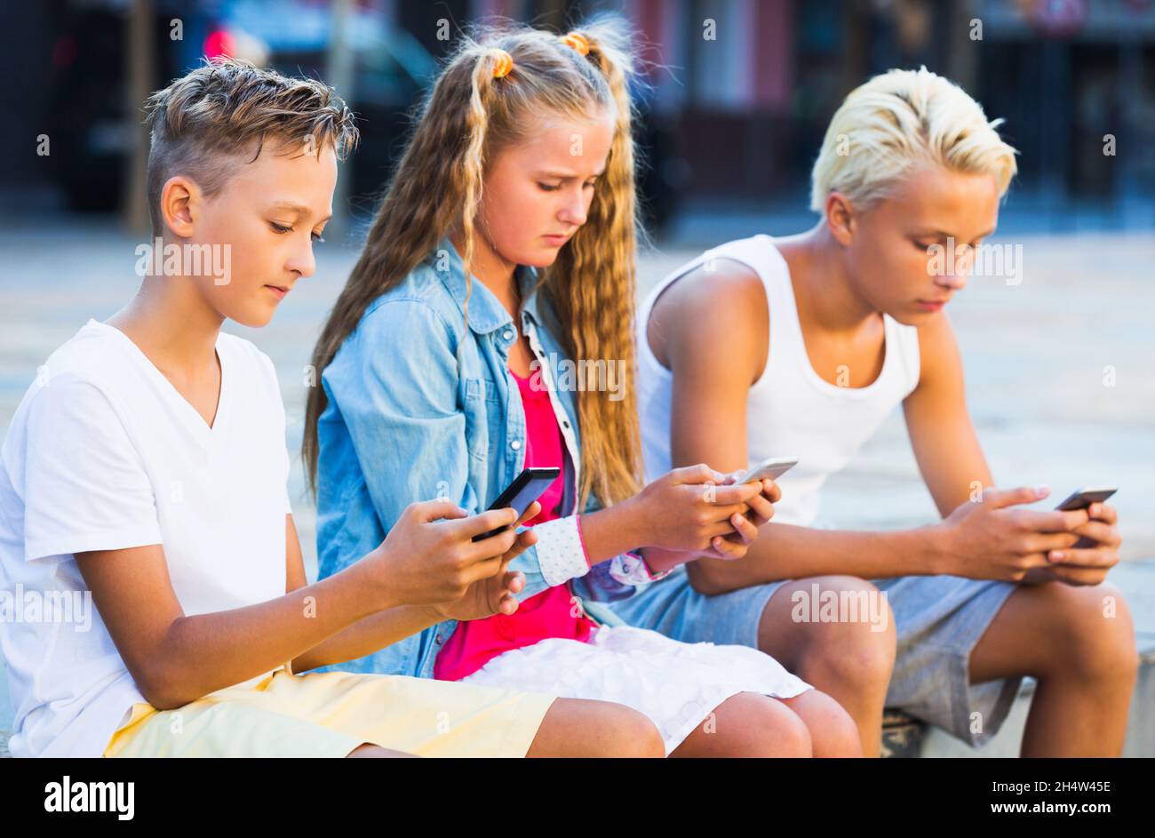 Modern kids using mobile gadgets Stock Photo - Alamy