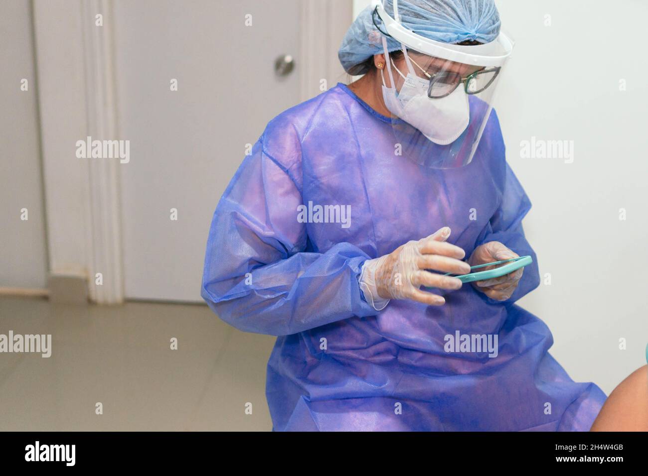 Female dentist texting through smart phone in clinic Stock Photo - Alamy