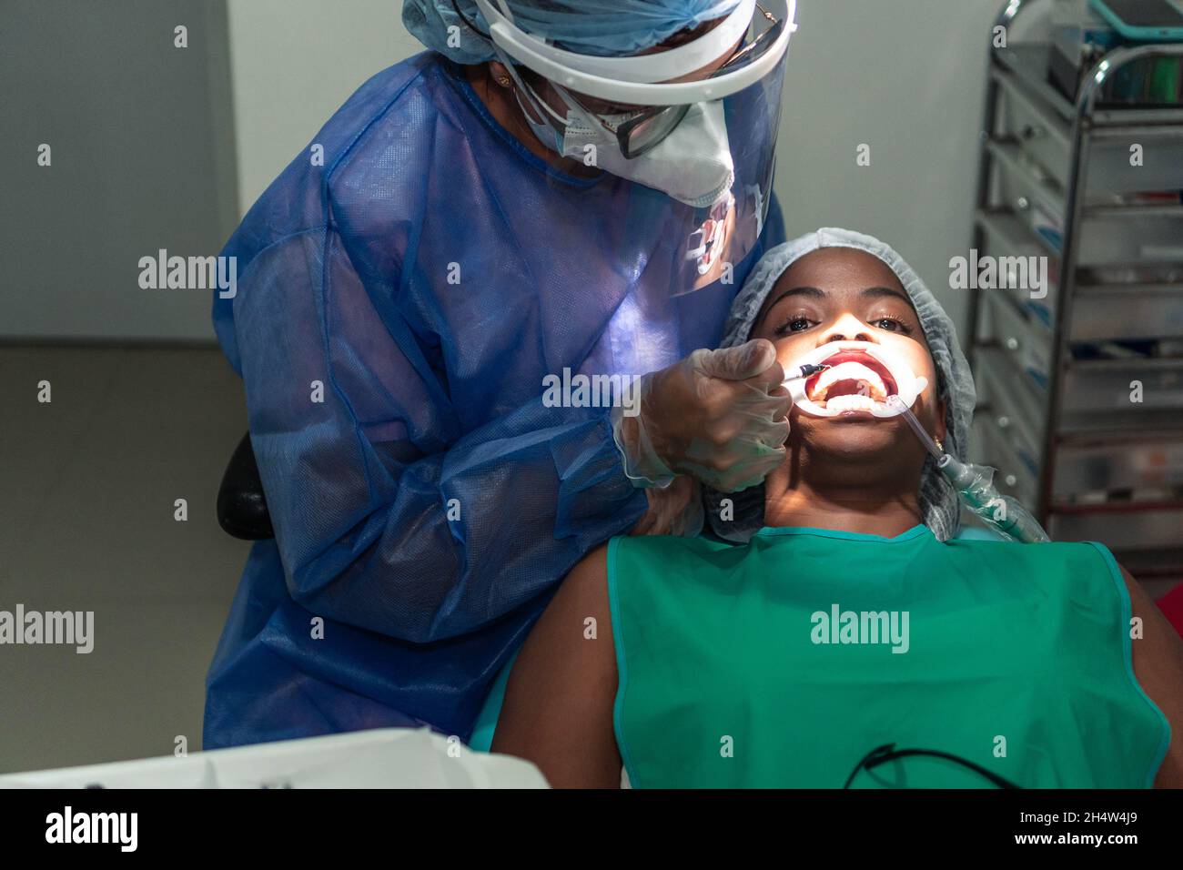Female dentist doing dental treatment hi-res stock photography and ...