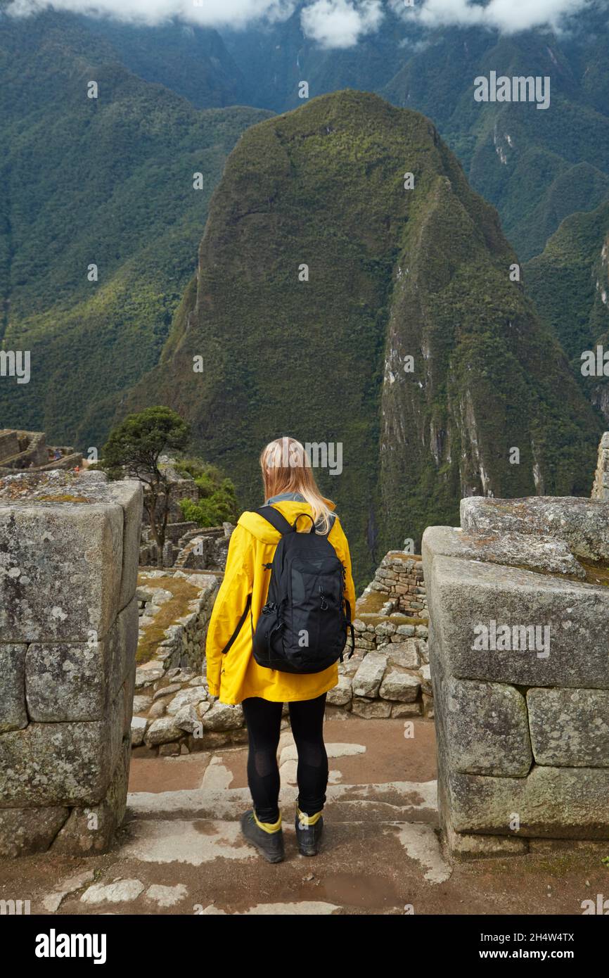 Tourist in doorway at Machu Picchu 15th century Inca ruins (World ...