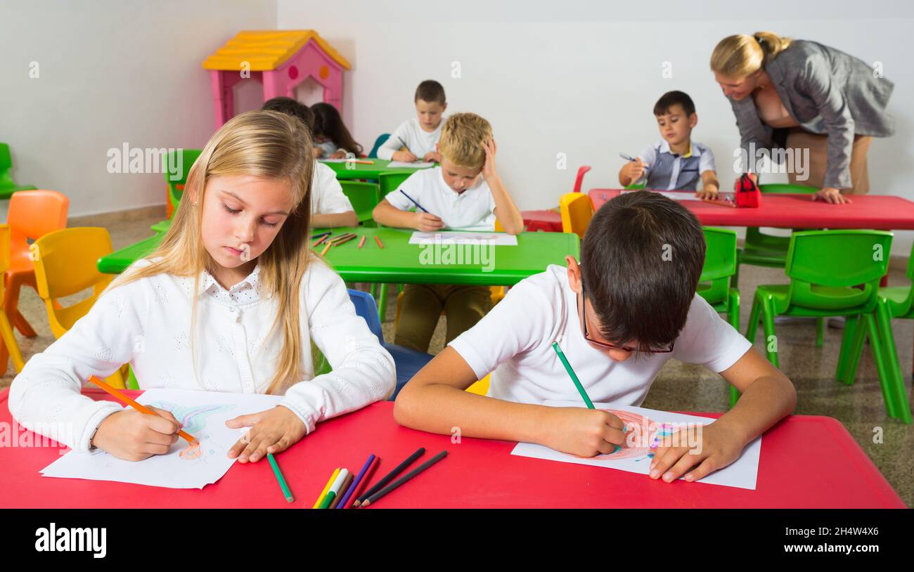 Boy writing in workbook hi-res stock photography and images - Alamy
