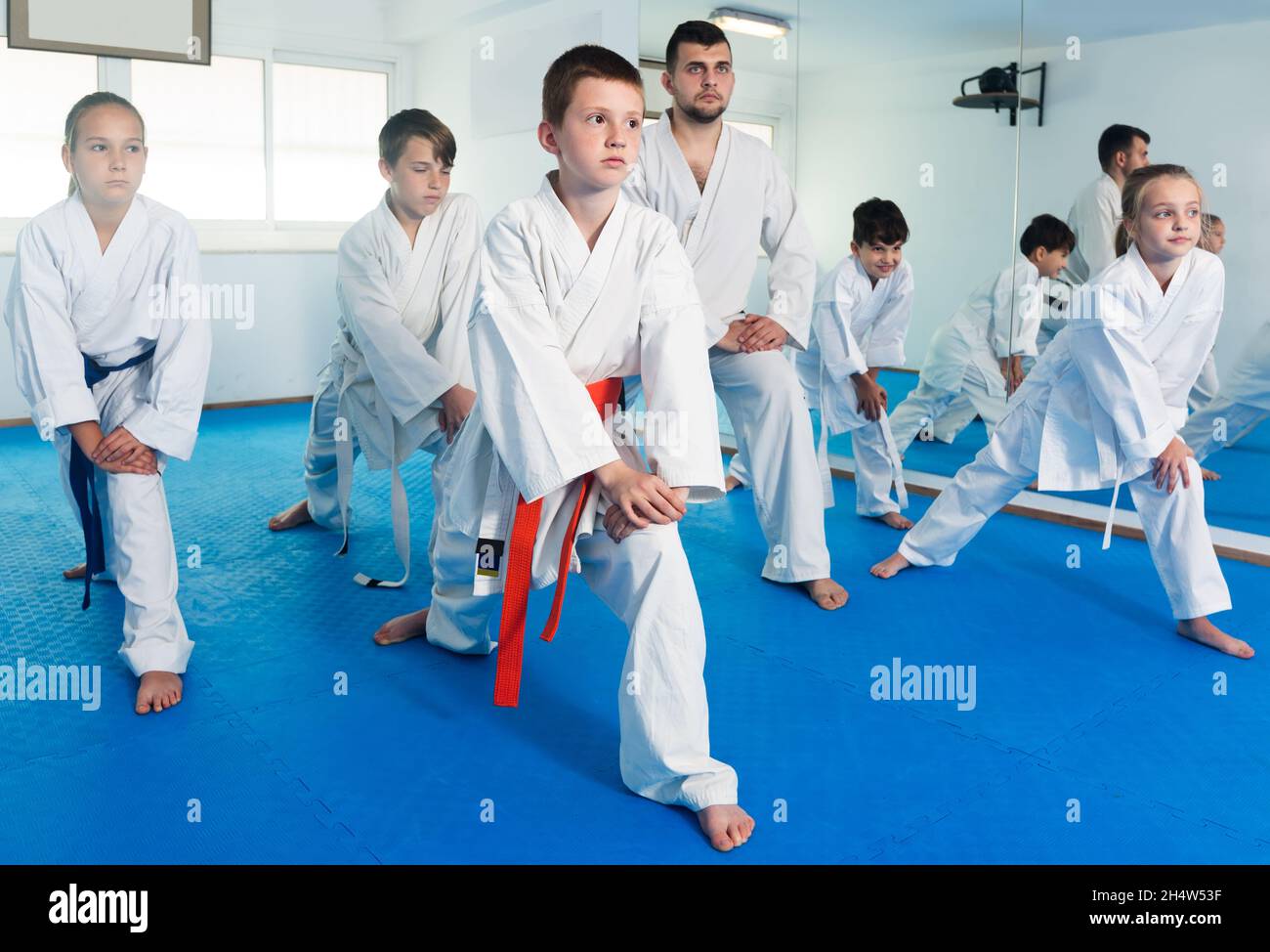 Children stretching before karate class Stock Photo - Alamy