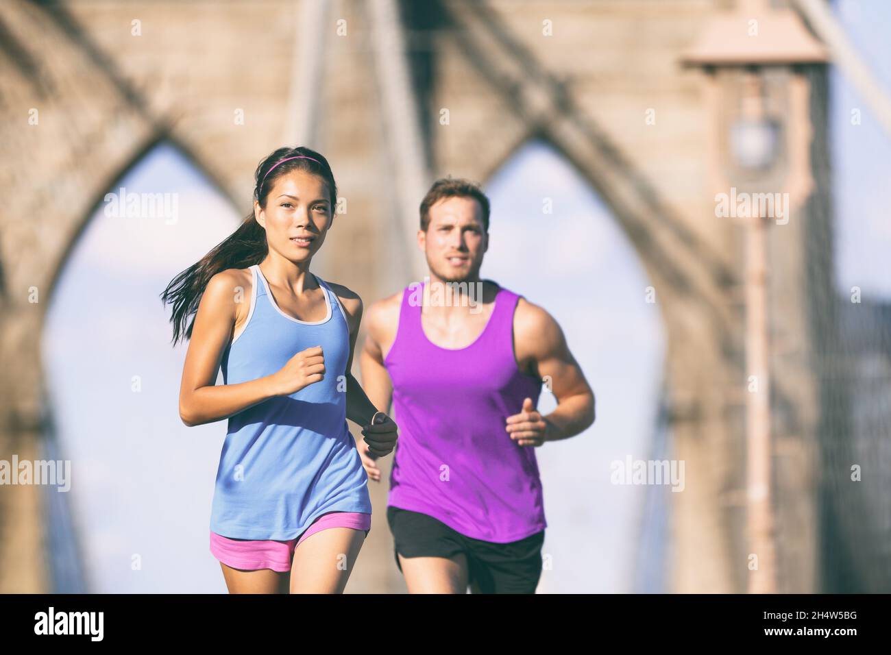 New York city runners running training for marathon on Brooklyn bridge ...