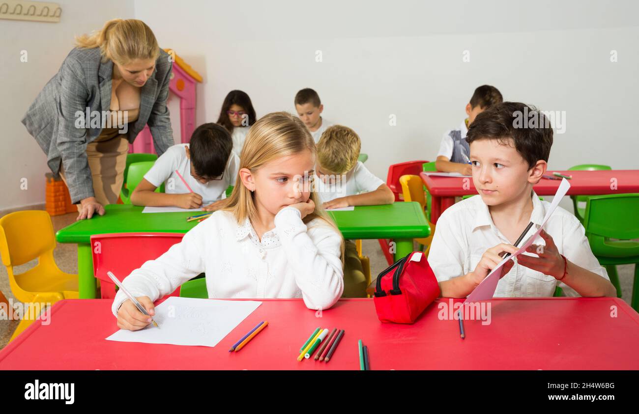 Portrait of two schoolkids and their teacher Stock Photo - Alamy