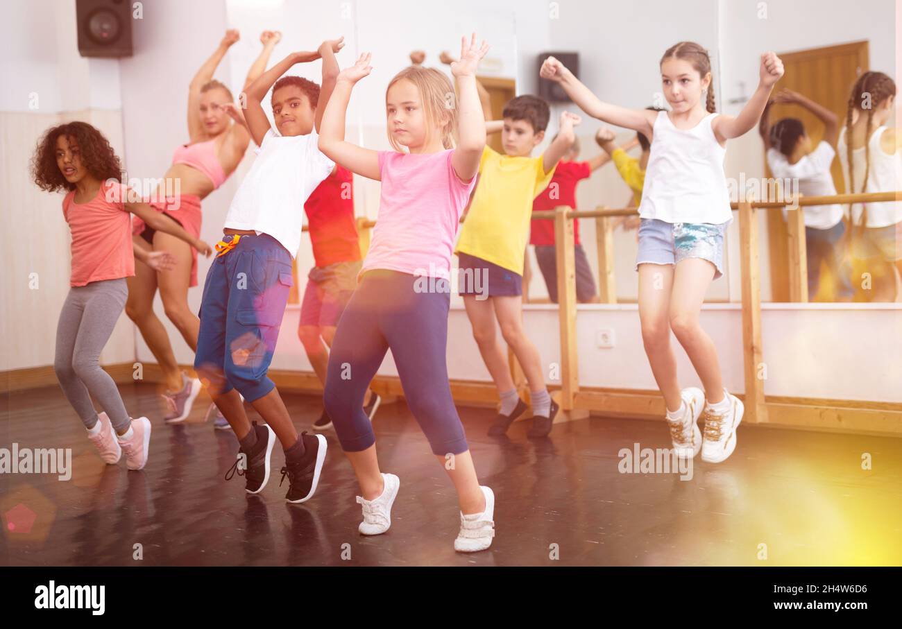 Group of tweens doing dance workout in choreography class Stock Photo ...