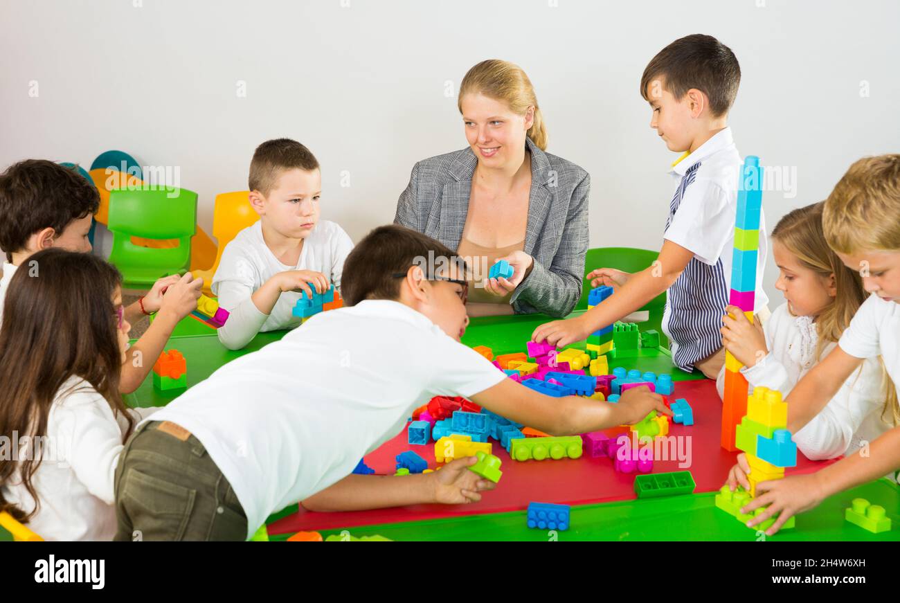 Group of schoolkids playing with toy bricks Stock Photo - Alamy