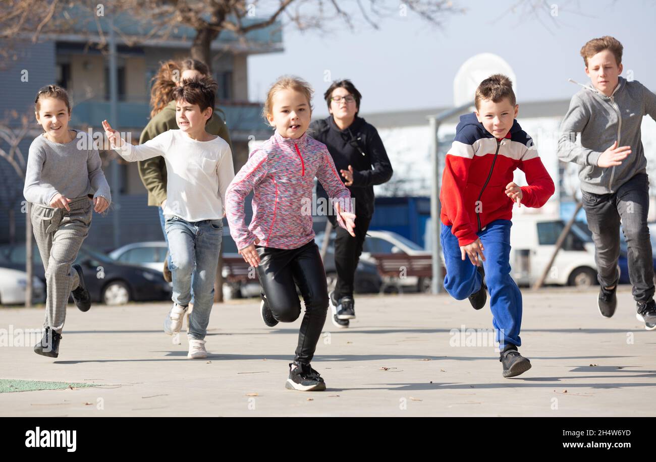Happy children running on city street Stock Photo - Alamy