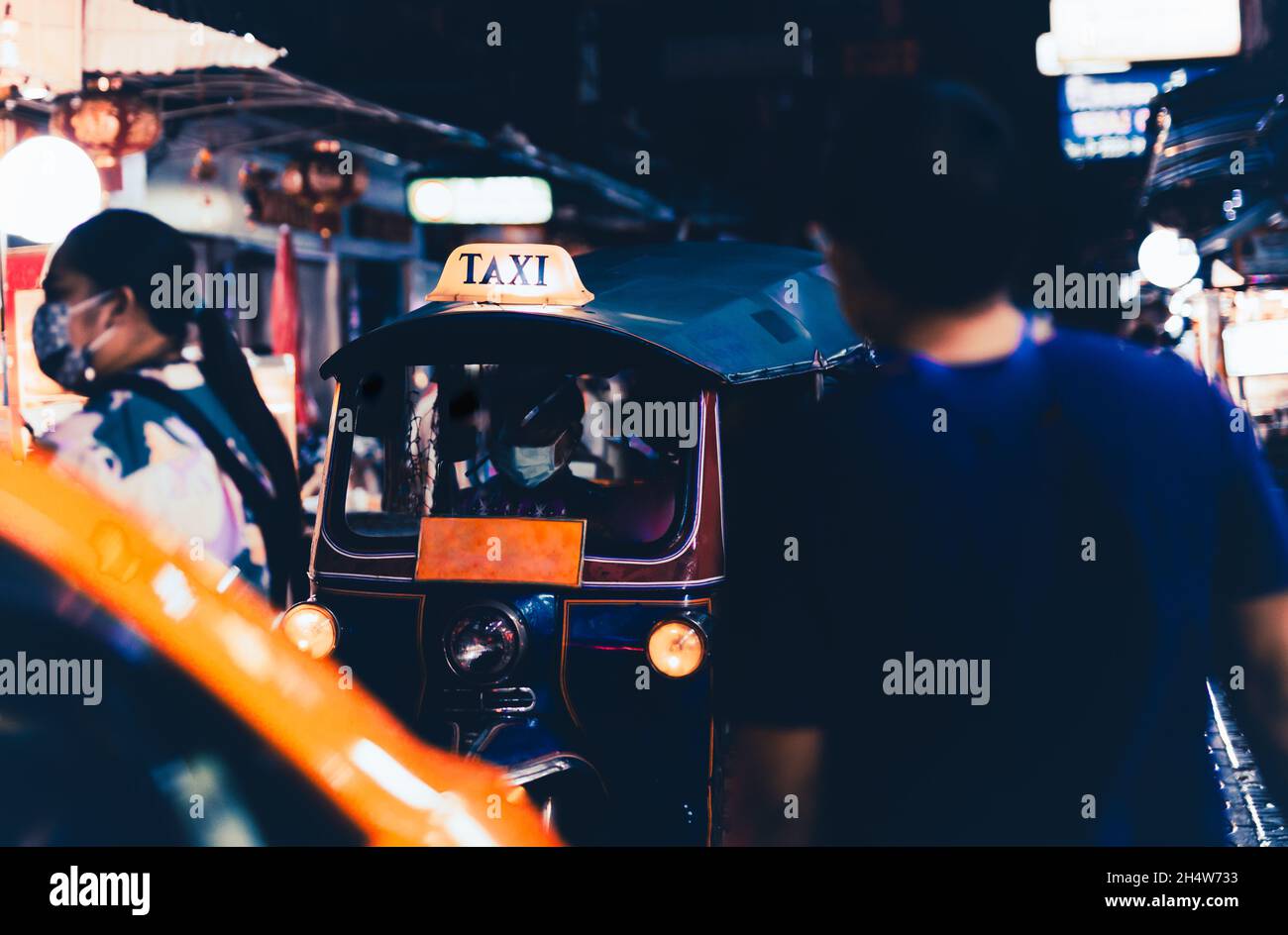 Famous Tuk Tuk with tourist walking on street at night market in Bangkok Stock Photo - Alamy
