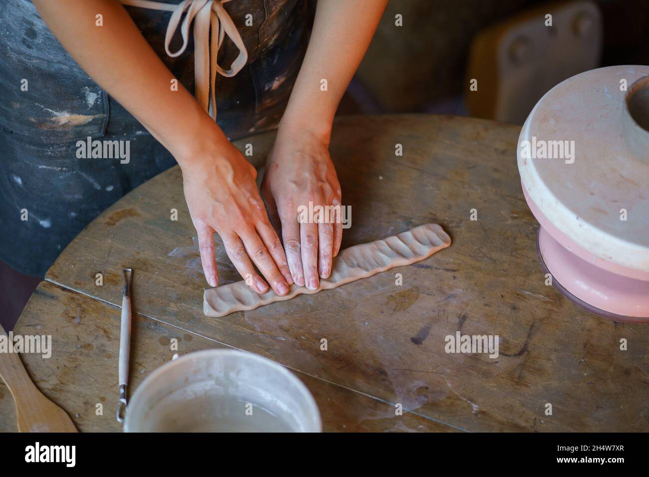 Handmade pottery creation: female craftswoman hands working with wet ...