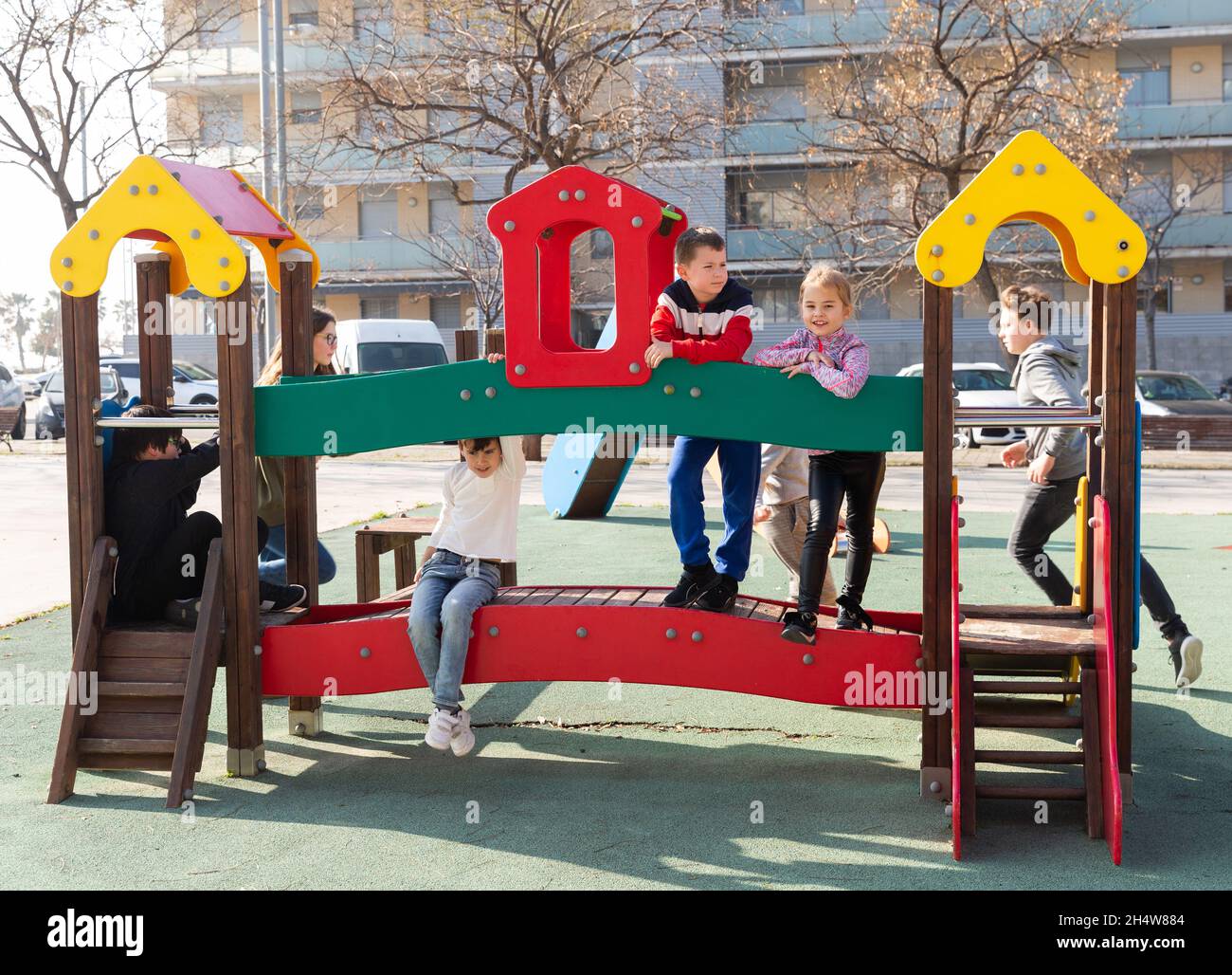 Smiling kids playing together on playground outdoors Stock Photo - Alamy