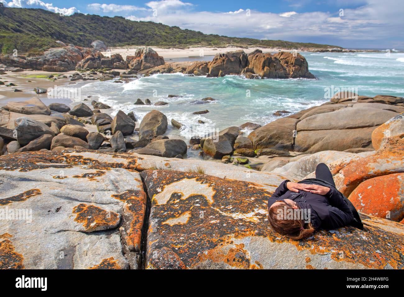 Woman lying on rocks hi-res stock photography and images - Alamy