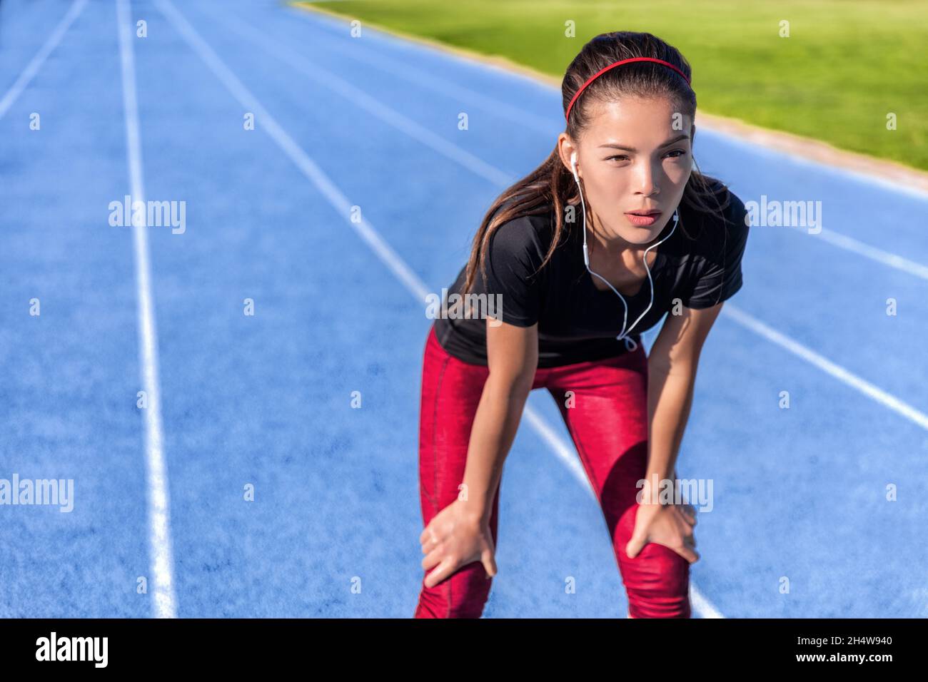 Focused and concentrated sport athlete getting ready to run race ...