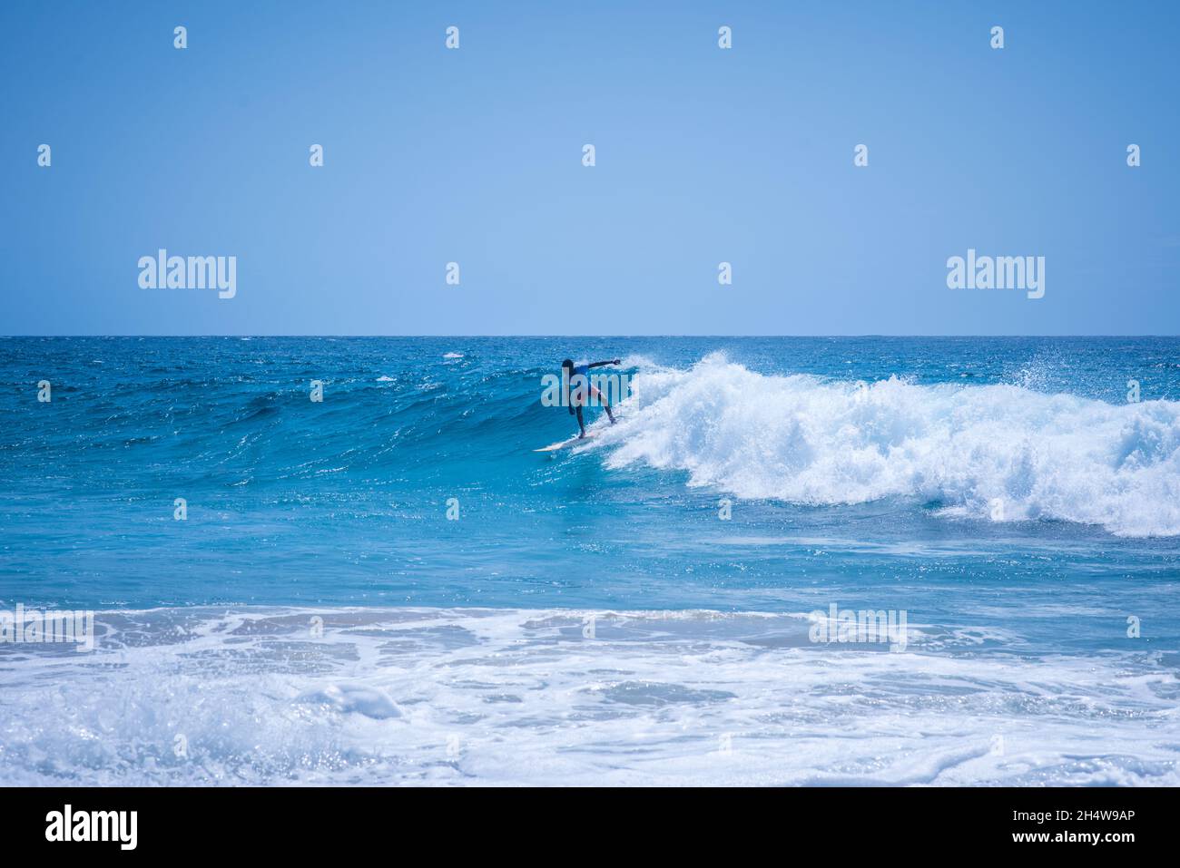 Man riding wave with his surfboard Stock Photo - Alamy