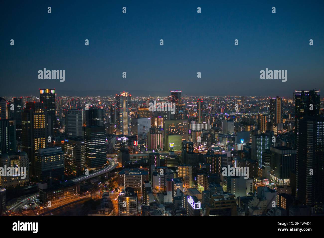 Aerial view of Osaka by night. Skyscrapers and the city in the distance ...
