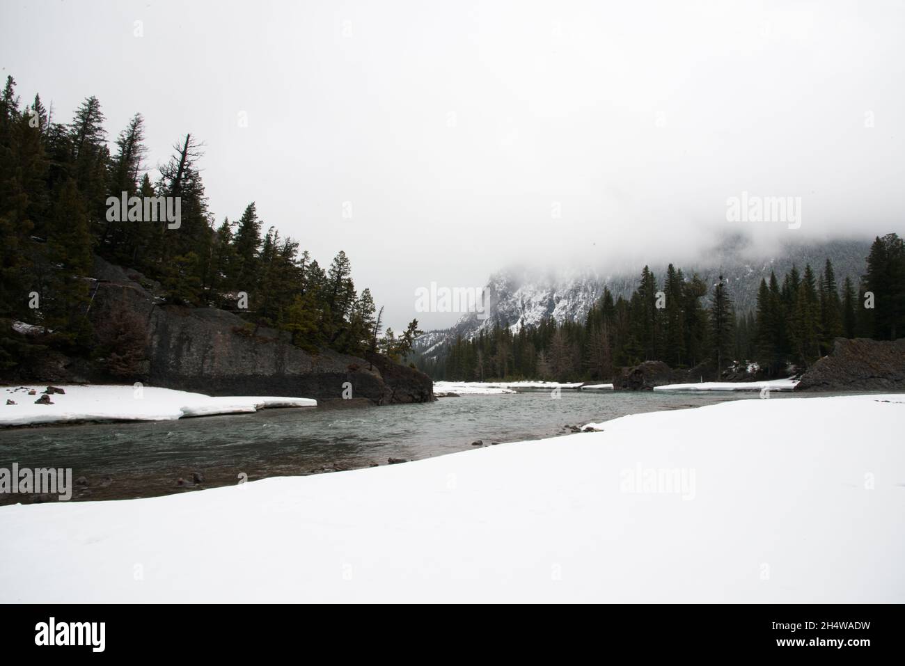 Beautiful view of Banff National Park with snow. River and forest on a ...