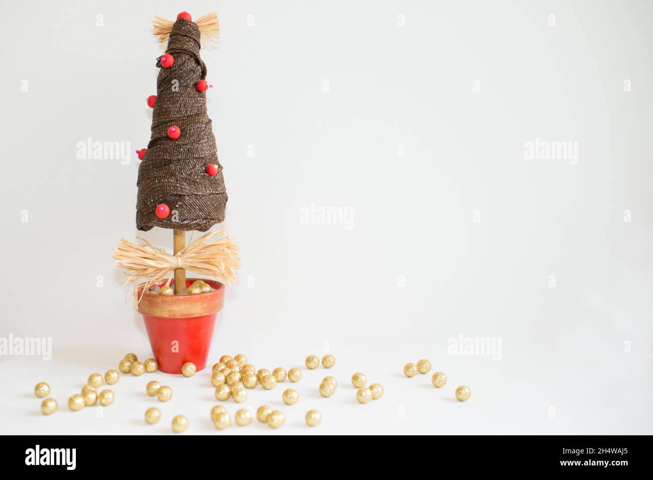 Handcraft Christmas tree and small golden balls with white background ...