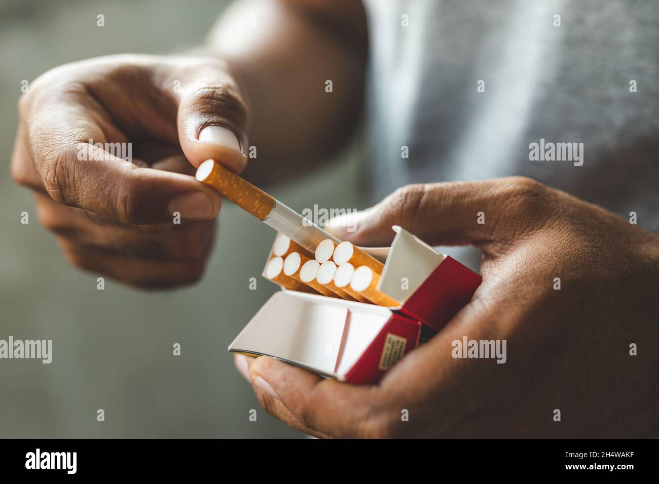A male hand holding white cigarette hi-res stock photography and images ...