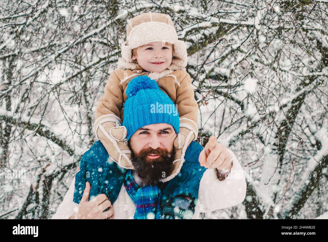 Winter, father and son play outdoor. Christmas family in snow. Merry ...