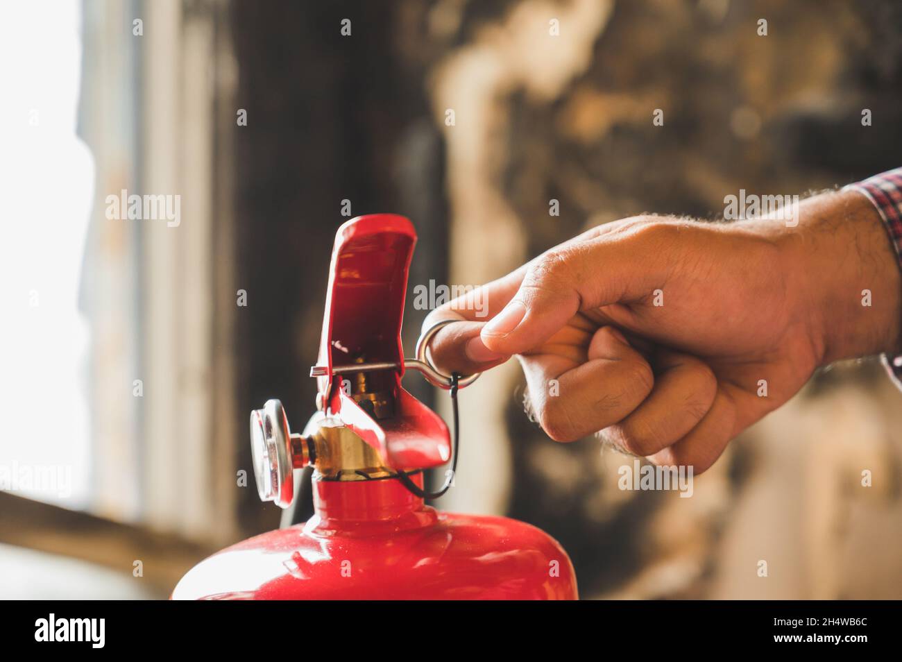 Close up hand Fireman using fire extinguisher fighting. Hand pulling ...
