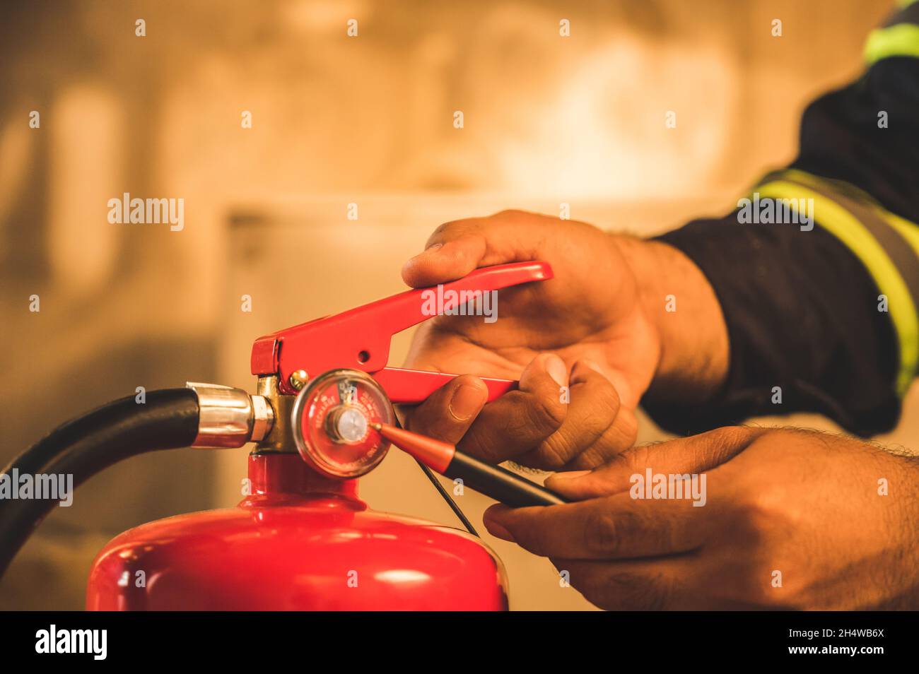 Close up hand Fireman,Firefighter checking the fire extinguisher Stock Photo - Alamy